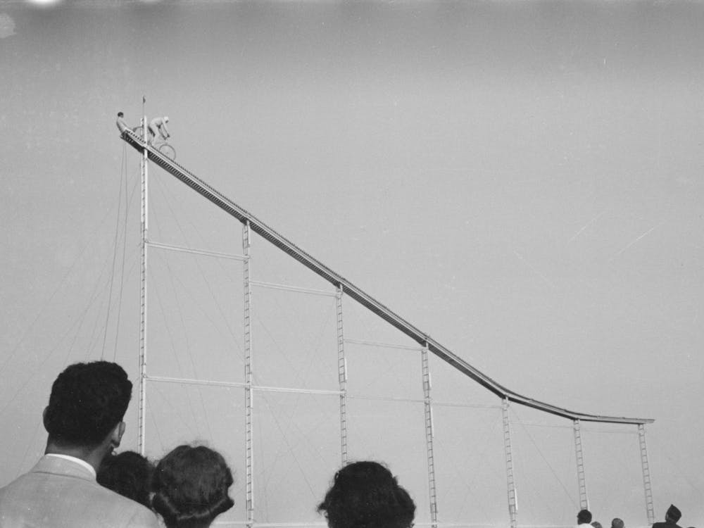 Crowd Watch Daredevil Preparing To Dive Into Water From Cycle Down ...